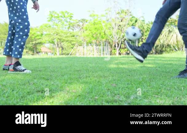 Family playing soccer in park in afternoon. German white male and young ...