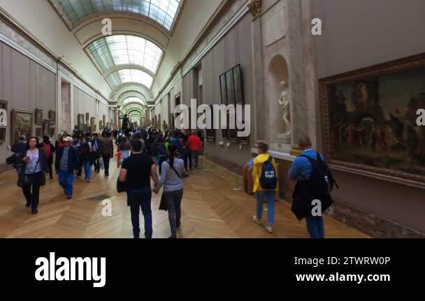 FRANCE, PARIS - circa JUN, 2017: Tourists visiting art gallery in Louvre Museum, one of largest ...