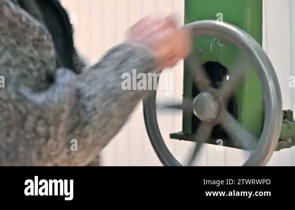Close-up of hands A male researcher rotates the manual wheel of the ...