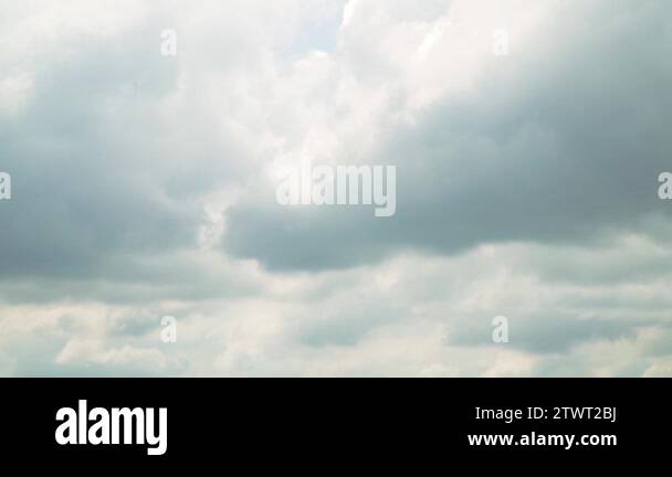 A sky with gray rain clouds through which the sun rays Stock Video ...