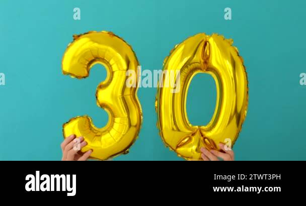 Gold foil number 30 thirty celebration balloon Stock Video Footage - Alamy