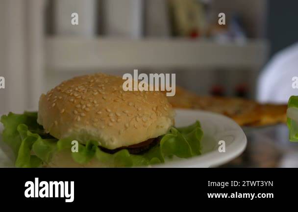Hungry man taking hamburger from fridge and chewing, diet failure, junk ...
