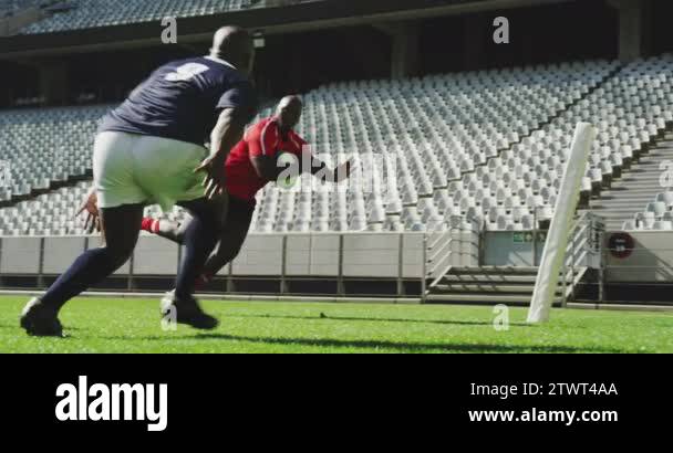 Side view of African American rugby players playing rugby match in ...