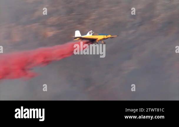 Fire fighting plane spraying fire extinguisher on burning forest, Mount ...