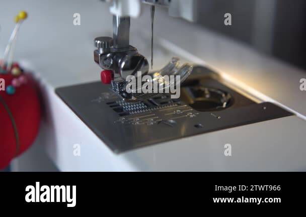 Tailor set up the needle for sewing. Sewing machine thread and lace ...