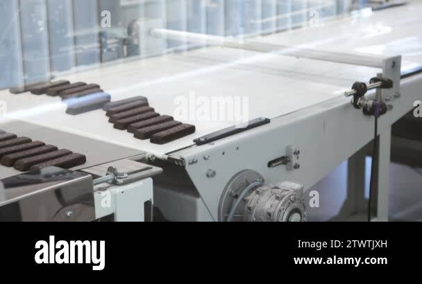 Ready chocolates on the production line at chocolate factory ...