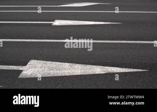 Cars crossing smooth road. One-way traffic. Cars in motion. Focus on ...