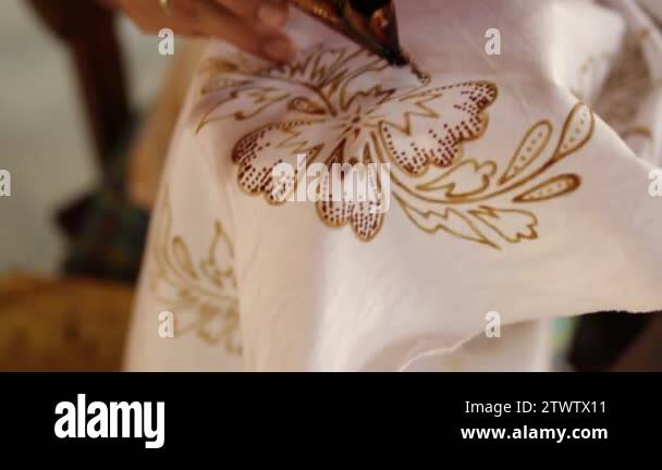 Detail of waxing the drawing to textile for making batik. Bali island ...