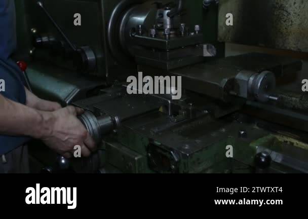Lathe in action. Old lathe in the lathe shop.The operator of the machine works on an old lathe ...