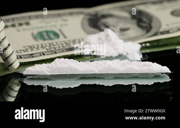 Cocaine snorted on a mirror through rolled 100 dollar bank note Stock ...
