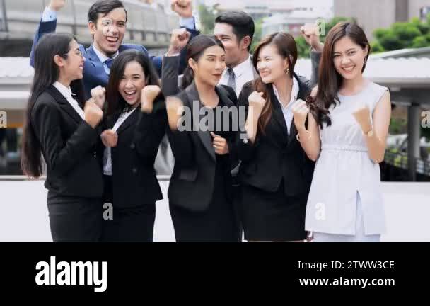 Young Asian chinese business team cheering, smiling, excited and very ...