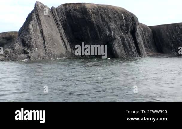 Stone rocks among water surface of Arctic Ocean on New Earth Vaigach ...