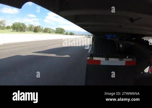 Semi-Truck Trailer Exterior Highway Driving. Camera Angle is underneath ...