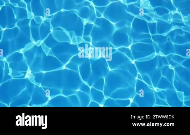 Beautiful swimming pool water glittering with its moving blue waves An ...