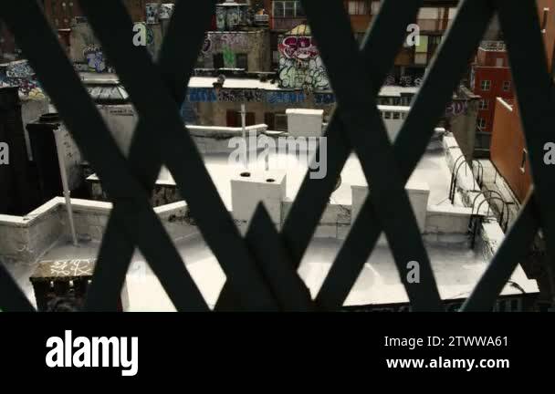 Moving shot from left to right of Buildings with graffiti and rooftop ...