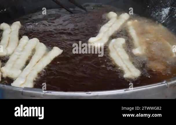 Cook prepare Youtiao, also known as Chinese fried churros, Chinese ...