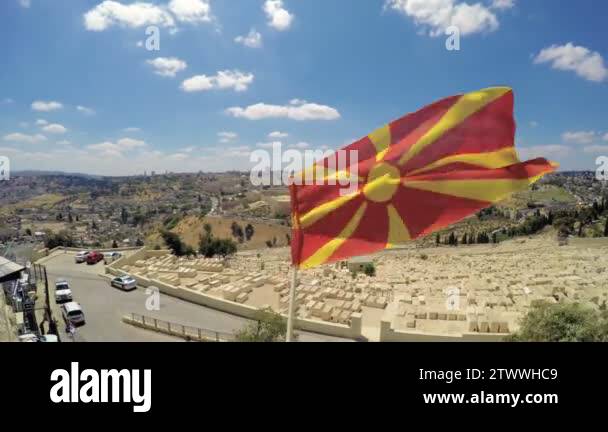 JERUSALEM, ISRAEL - circa JUN, 2017: Macedonian flag wave over View of ...