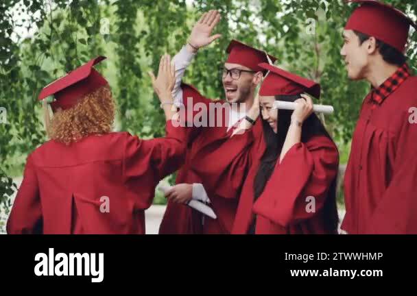 Multiracial group of young people students are doing high-five on ...