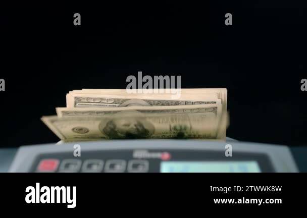 Banknote counter counting dollar bills. Money counting machine ...