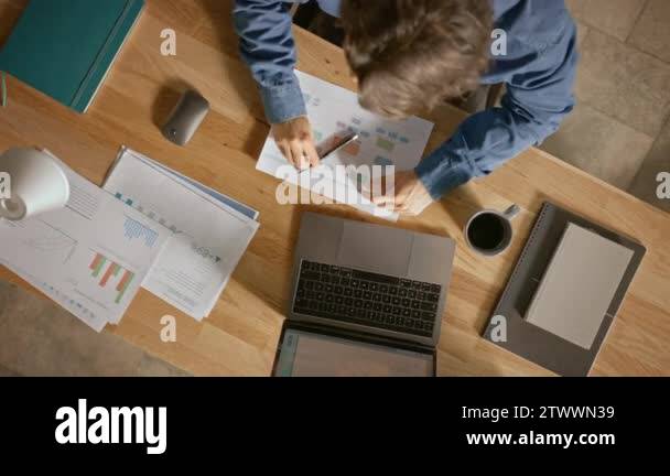Businessman Sitting at His Desk in the Office Uses Laptop Computer ...