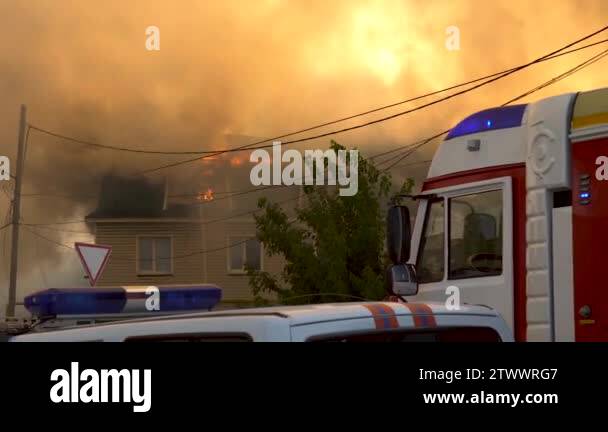 Firefighters extinguish a three-story house. Fire engines on a ...