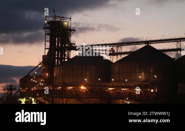Panorama of big grain terminal at seaport in the evening. Cereals bulk ...