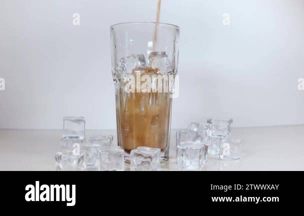 A refreshing drink of stake is poured into a glass beaker with a tube ...