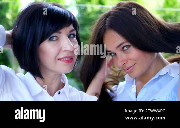 Portrait of two pleasant smiling, beautiful real 40 years old women ...