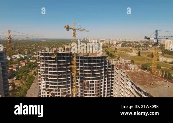 Construction of houses. Drone fly over construction site with tower ...