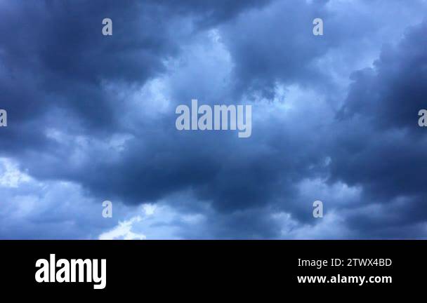 Stormy cloud disappear in the hot sun on blue sky. Cumulus dark clouds ...