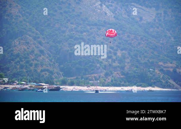 Tourists flying on a parachute behind a boat. Oludeniz, Turkey, 4K ...