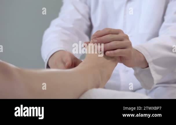 Physician examining patient sprained leg, first aid in trauma clinic ...