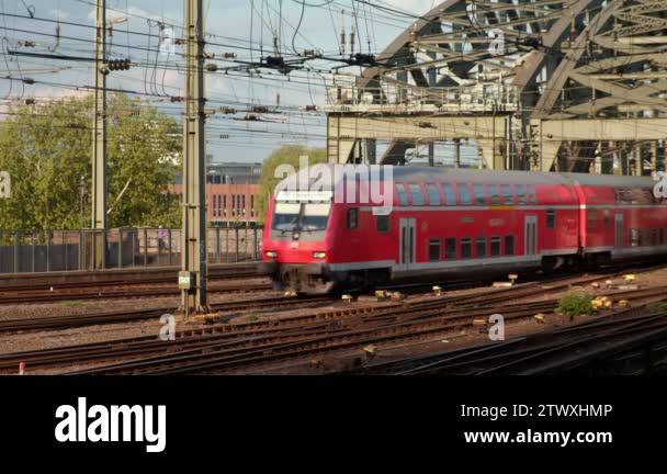Static clip of a red DB train crossing Hohenzollernbrucke in Colgone ...
