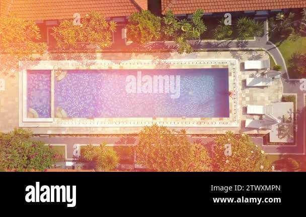 AERIAL LENS FLARE TOP DOWN: Woman on summer vacation jumping head first ...