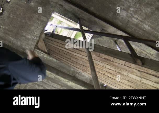 Low angle view of hand of man inside belfry tower holding and pulling ...