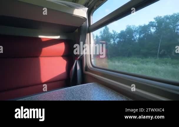 Side view of an interior of a coupe coach in a moving train. Travelling ...