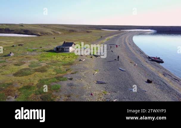 People near lone house on desolate Vaygach Island in desert Stock Video ...