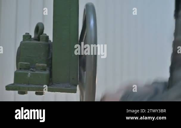 Close-up of hands A male researcher rotates the manual wheel of the ...