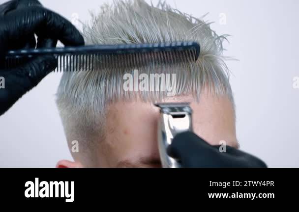 Male haircut with electric razor. Close up of man hair cut. Male hands ...