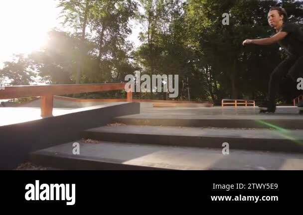 A young athlete performs a trick on rollers - jumps through the ...