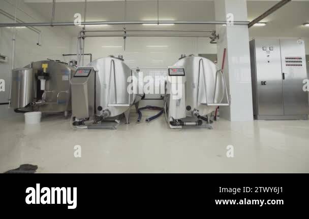 Milk factory equipment. Three pasteurization tanks placed at factory ...