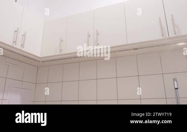 The camera moving from left to right and shooting a white cupboard ...