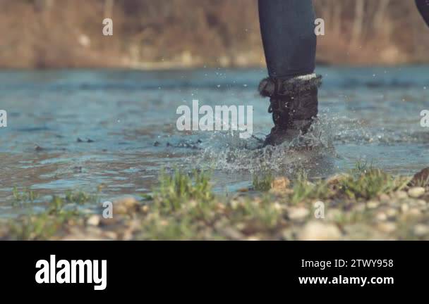 SLOW MOTION, LOW ANGLE: Unrecognizable girl in boots enjoying the ...