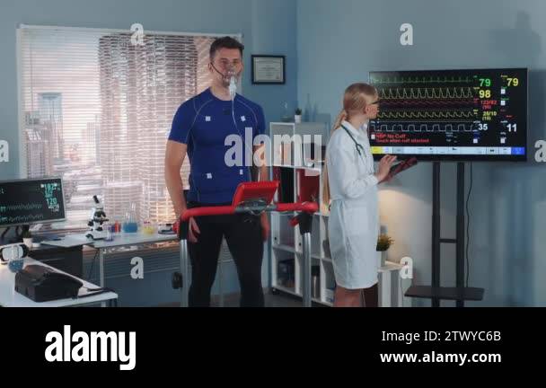 Cardio respiratory test: cardiologist with tablet monitoring athlete ...
