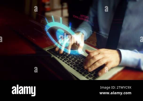 Hacker typing on laptop with cyber spy eye hologram screen over ...
