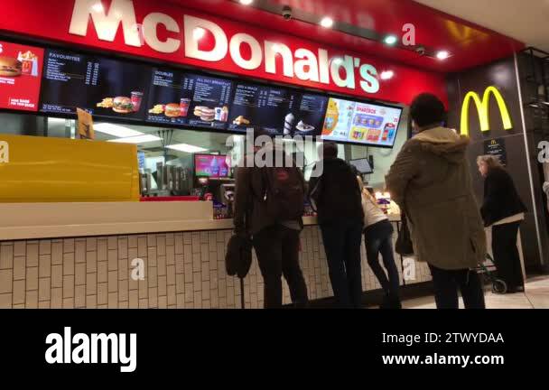 Customers buy fast food in Mcdonalds shop. McDonald's is the world's ...