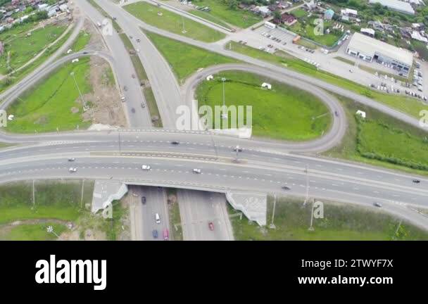 Aerial view of highway in city. Clip. Cars crossing interchange ...
