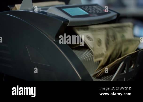 Automatic cash counting machine calculating 100 dollar banknotes ...