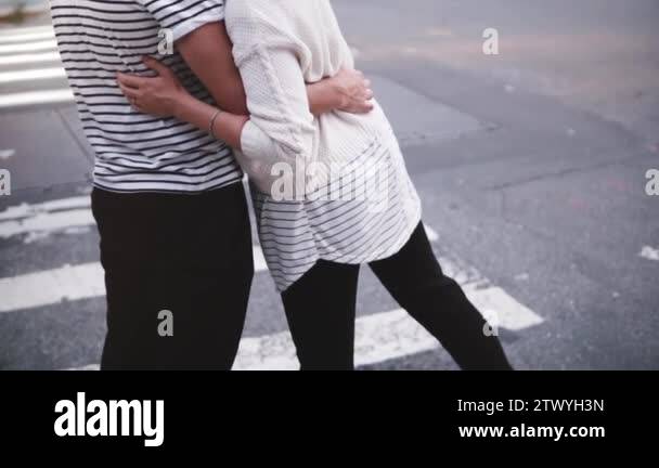 Slow motion young happy romantic couple standing together and hugging ...