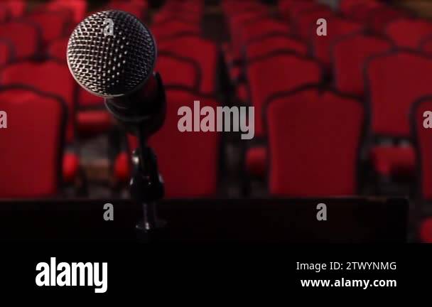 On an empty stage microphone in front of an empty hall. Scene ...
